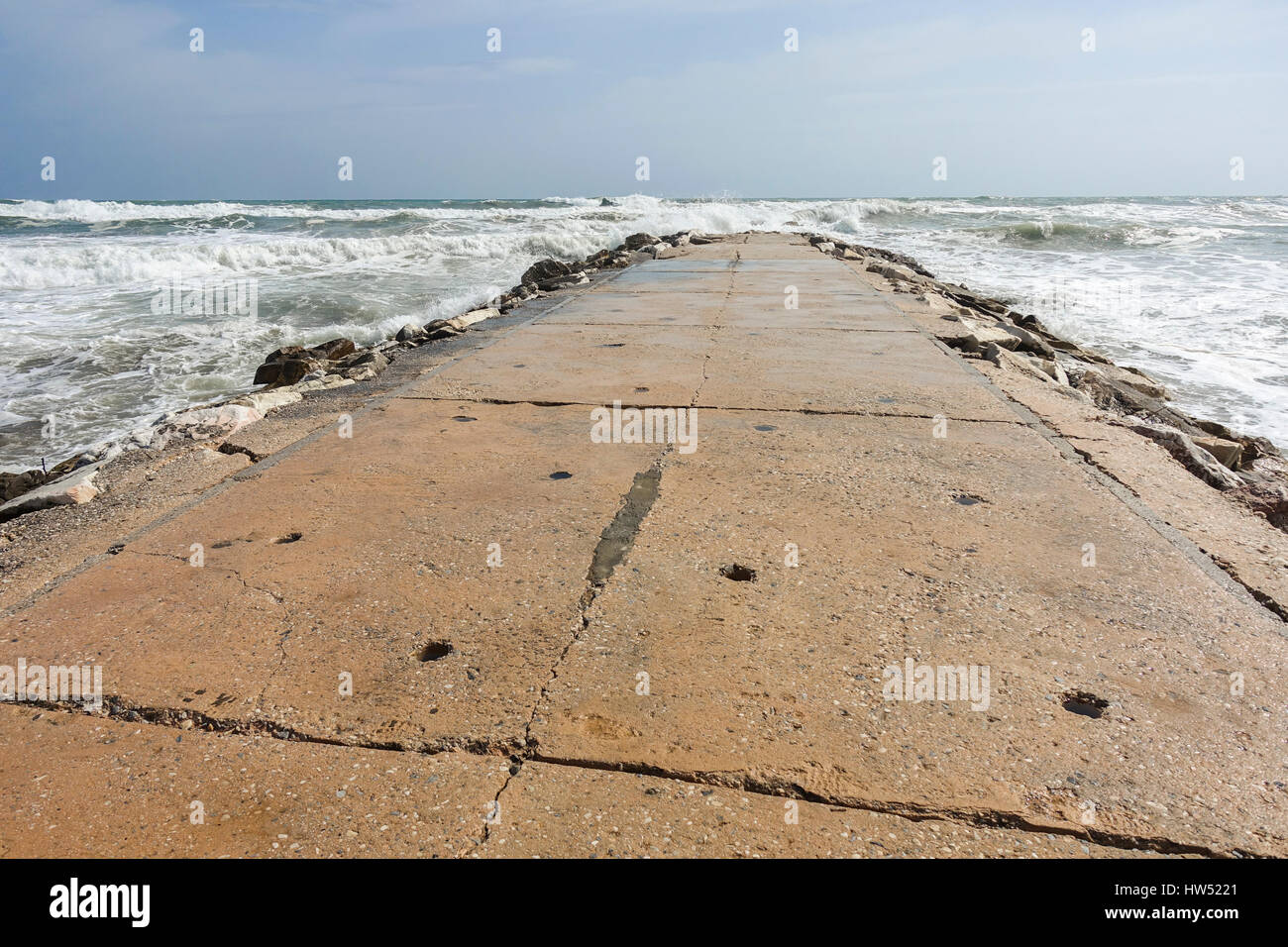 Pier quay high waves. Code orange is given for tide and wind ...