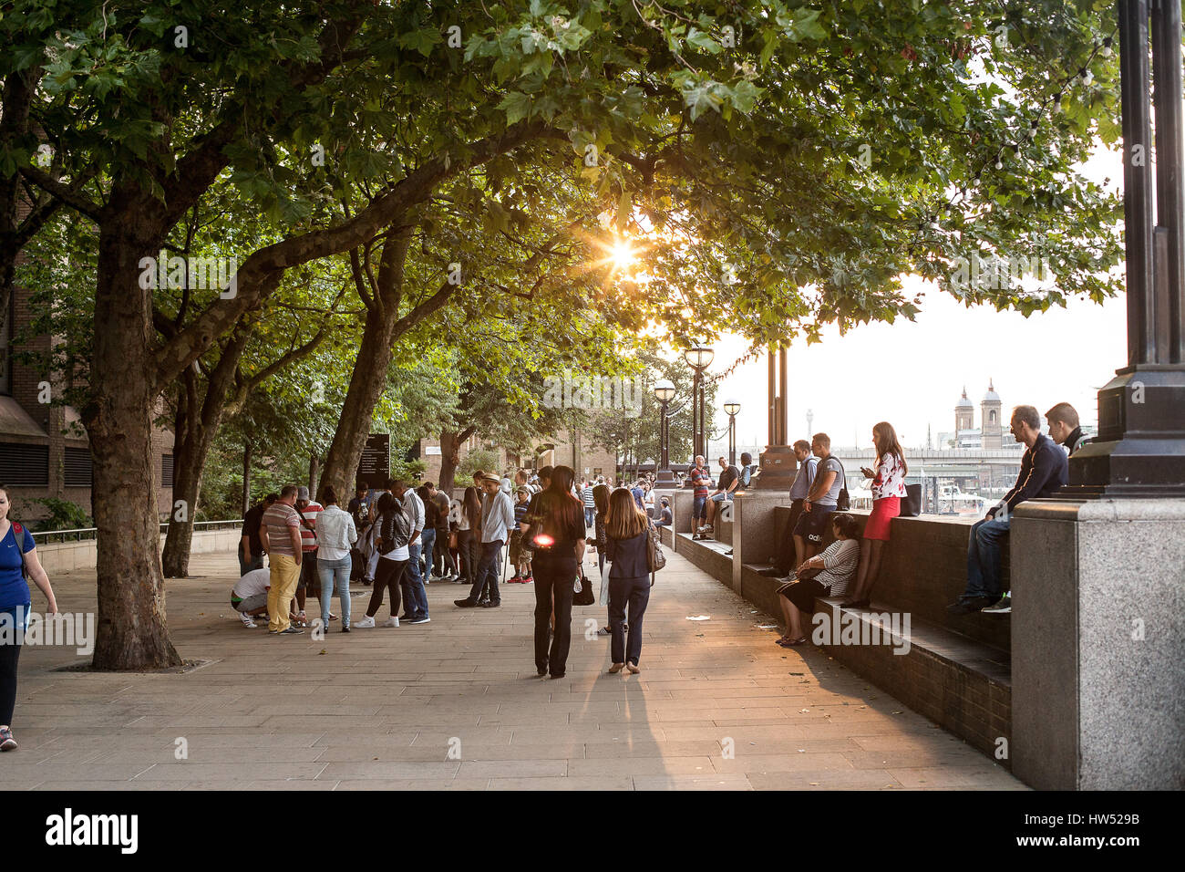 Pedestrians are walking on “The Queen’s Walk” in London, United Kingdom ...
