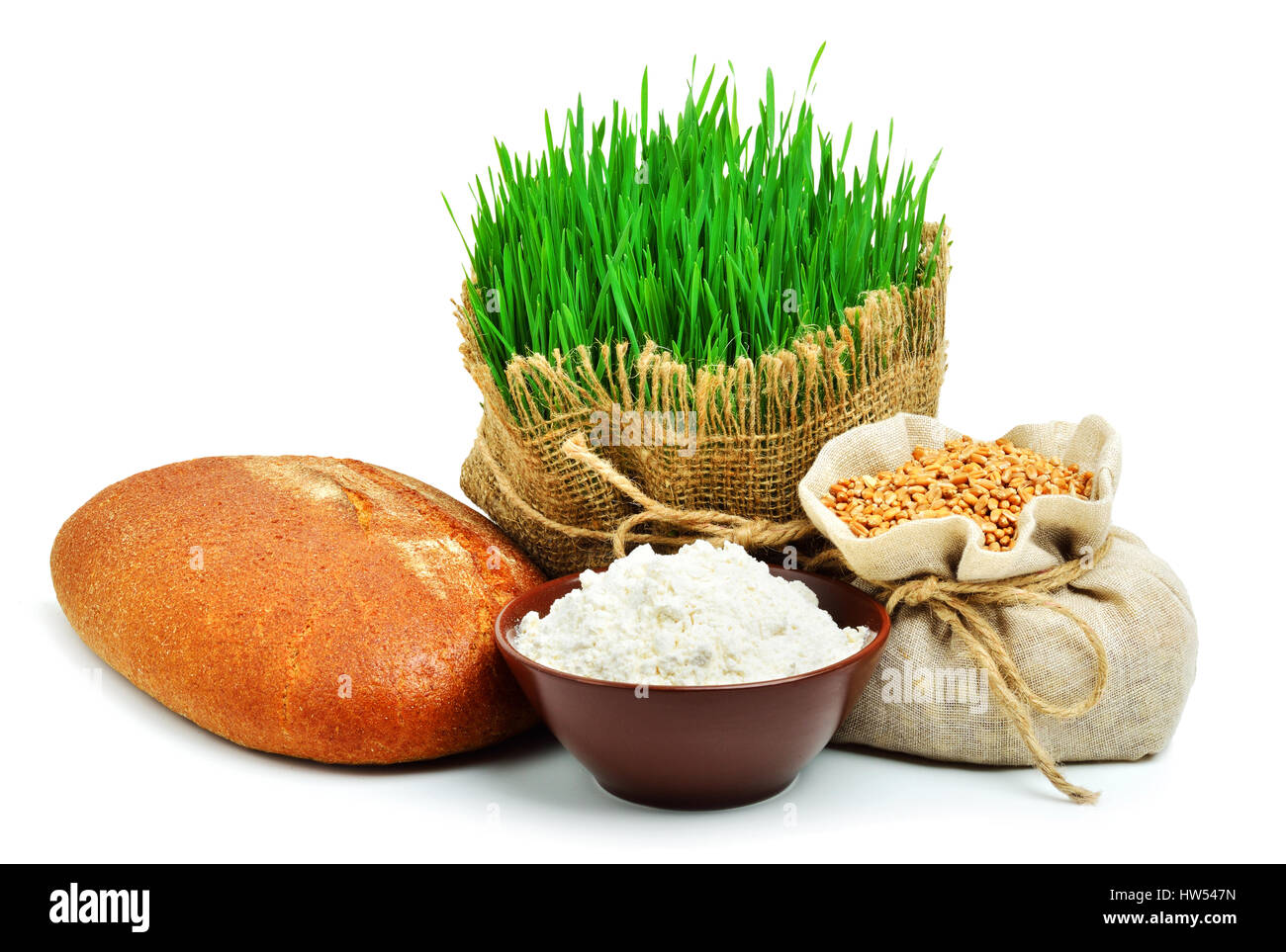 Fresh bread, flour, grain, green grass in the sack isolated on white ...