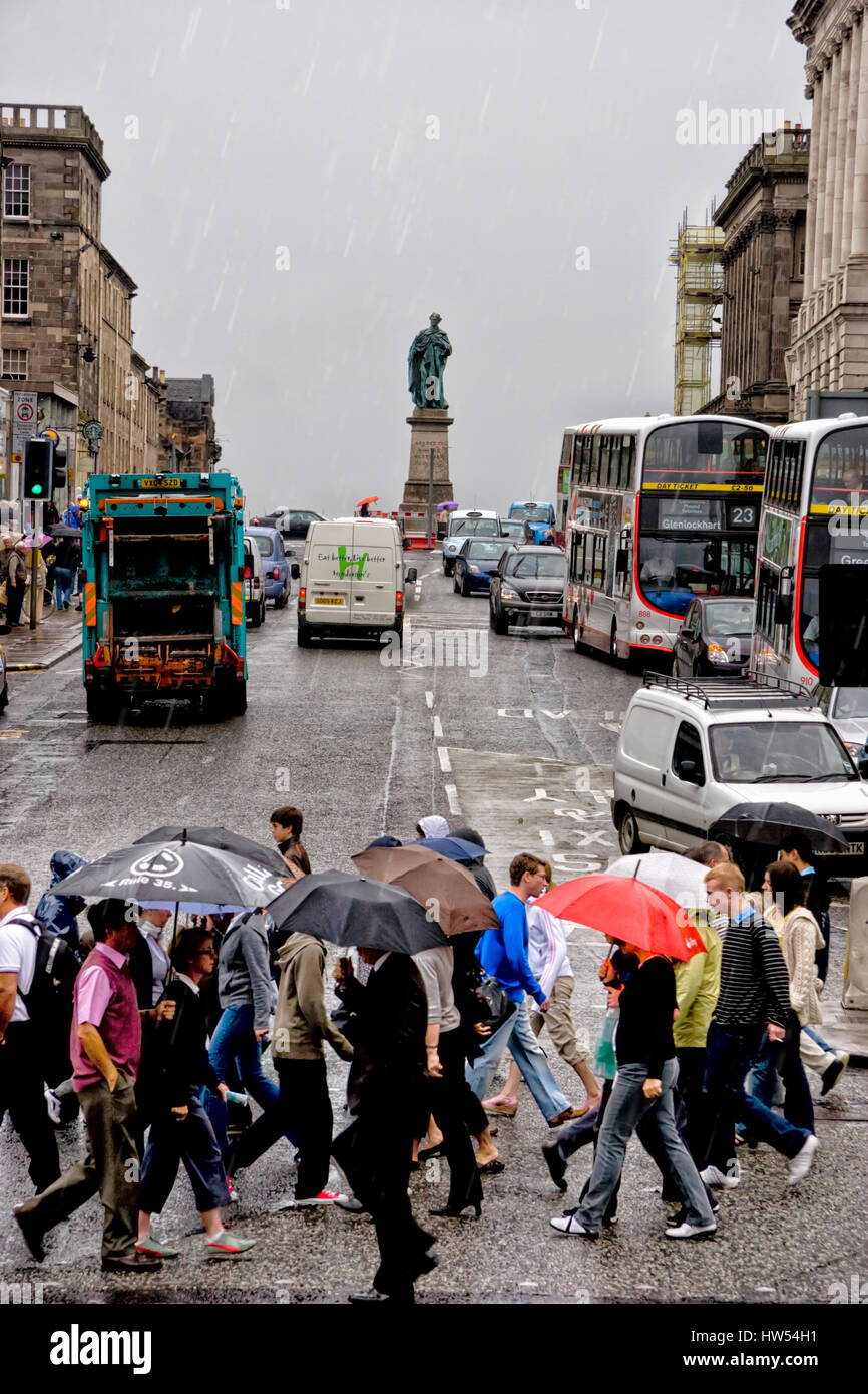 People crossing the road in the rain. Hanover Street, Edinburgh, UK ...