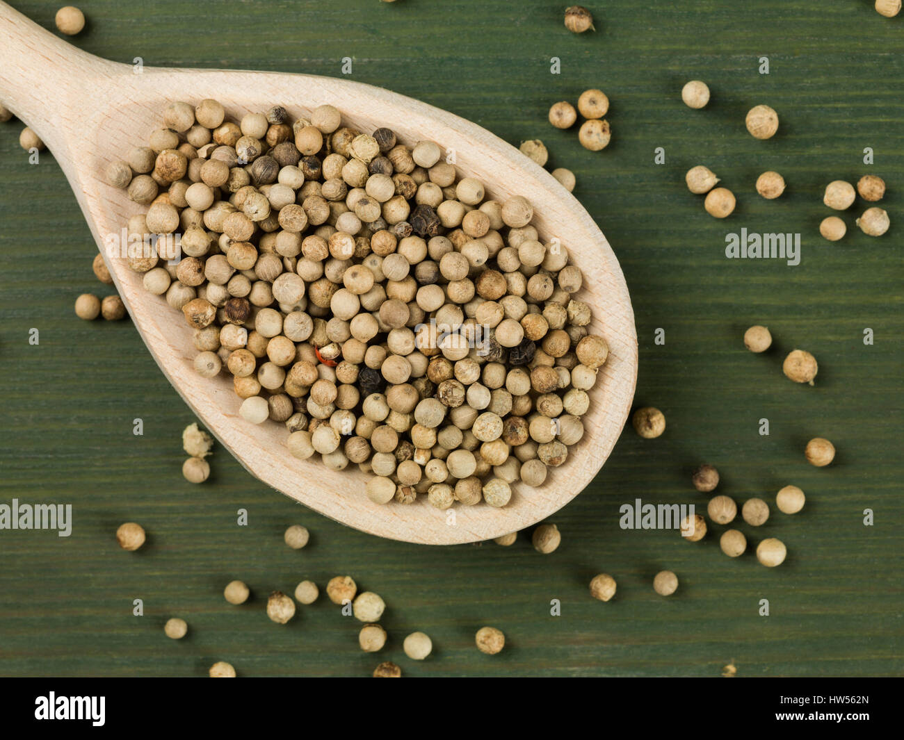 White Spicy Pepper Corns Against a Green Background Stock Photo - Alamy