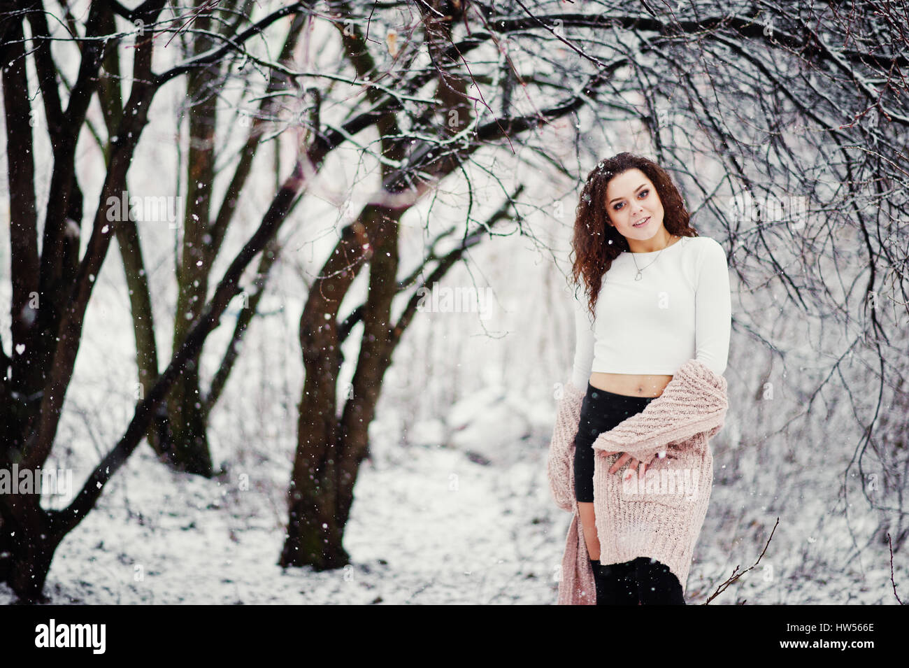 Curly brunette girl background falling snow, wear on warm knitted ...