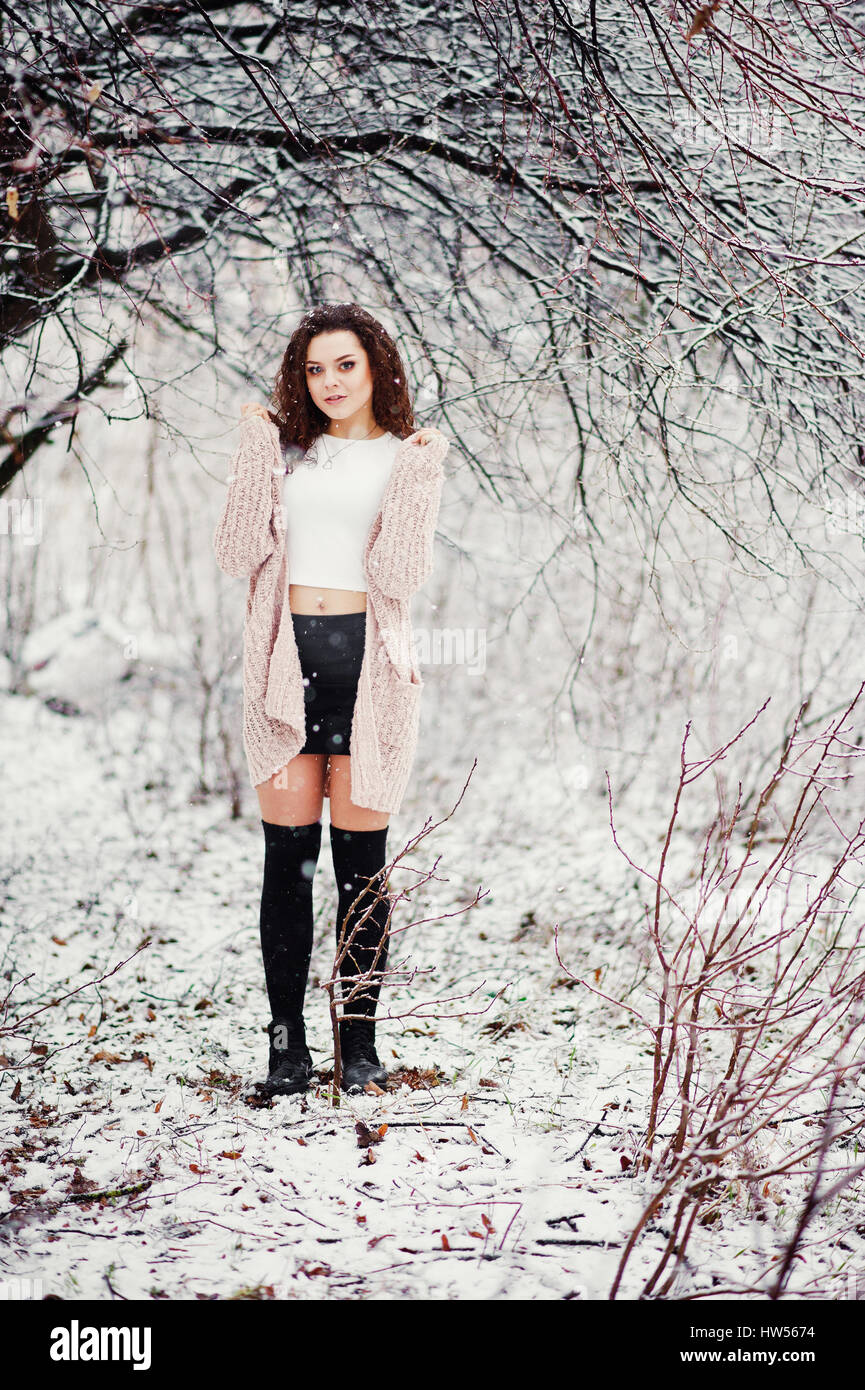 Curly brunette girl background falling snow, wear on warm knitted ...