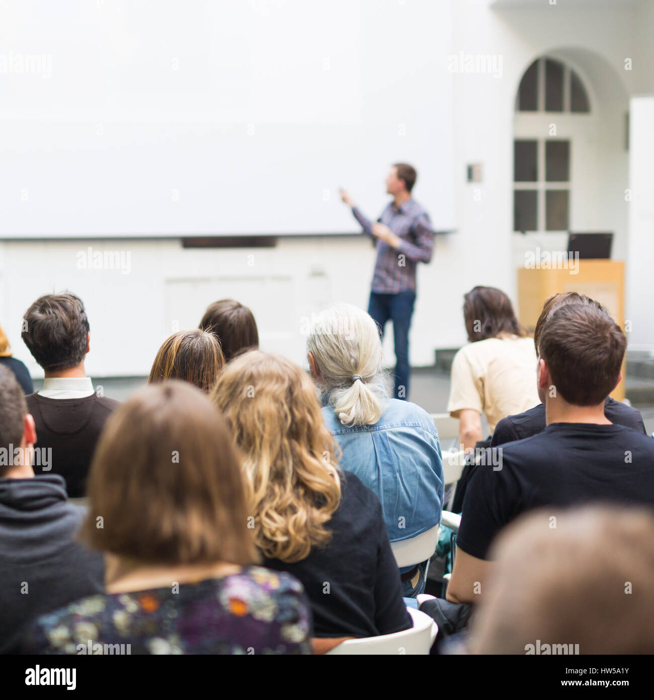 Man giving presentation in lecture hall at university Stock Photo - Alamy