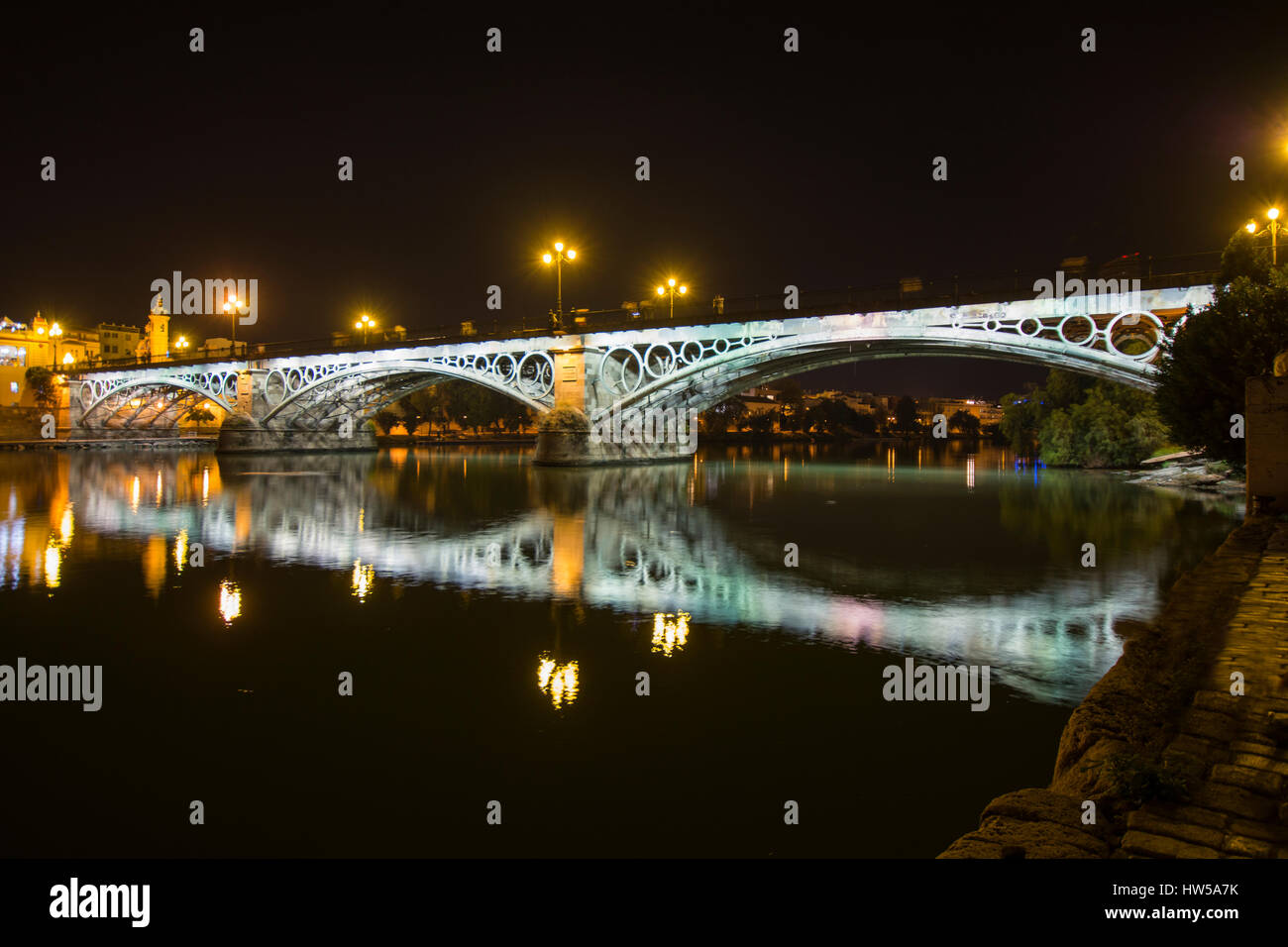 Night view of the Triana Bridge in Seville, Spain. Also called Isabel ...