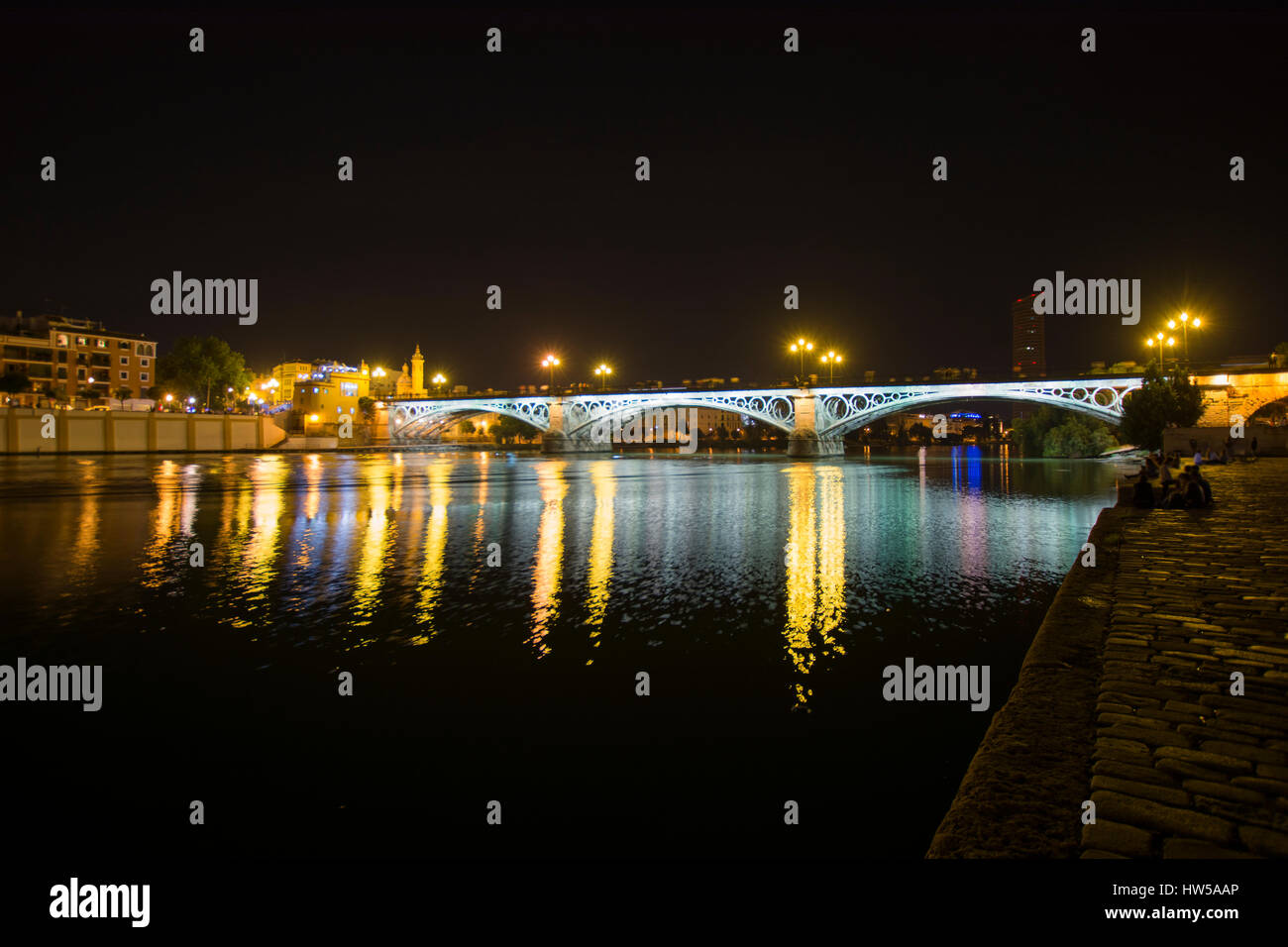 Night view of the Triana Bridge in Seville, Spain. Also called Isabel ...
