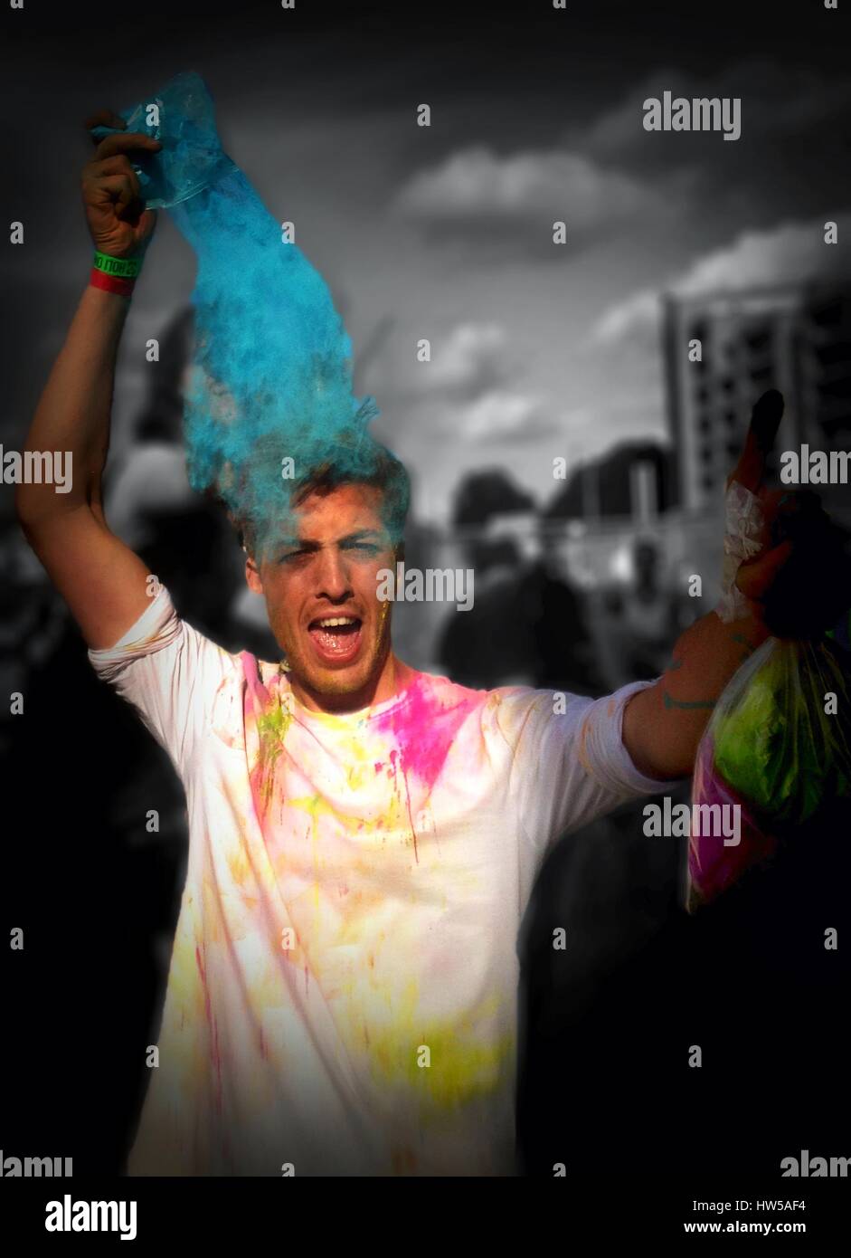 Man throwing colored powder in the air at Holi Festival, Battersea ...