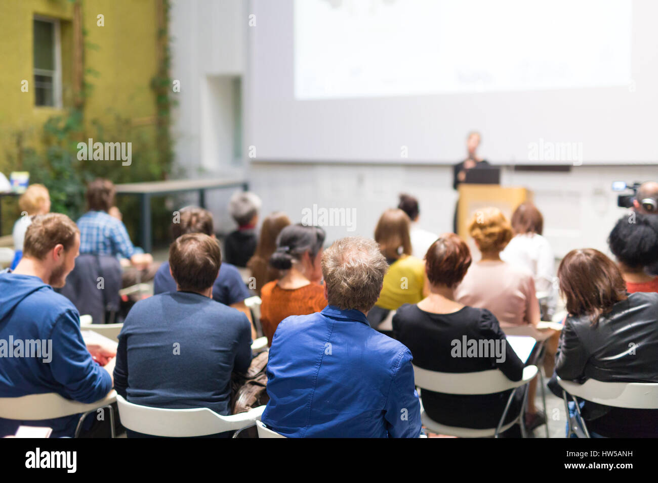 Woman giving presentation in lecture hall at university Stock Photo - Alamy