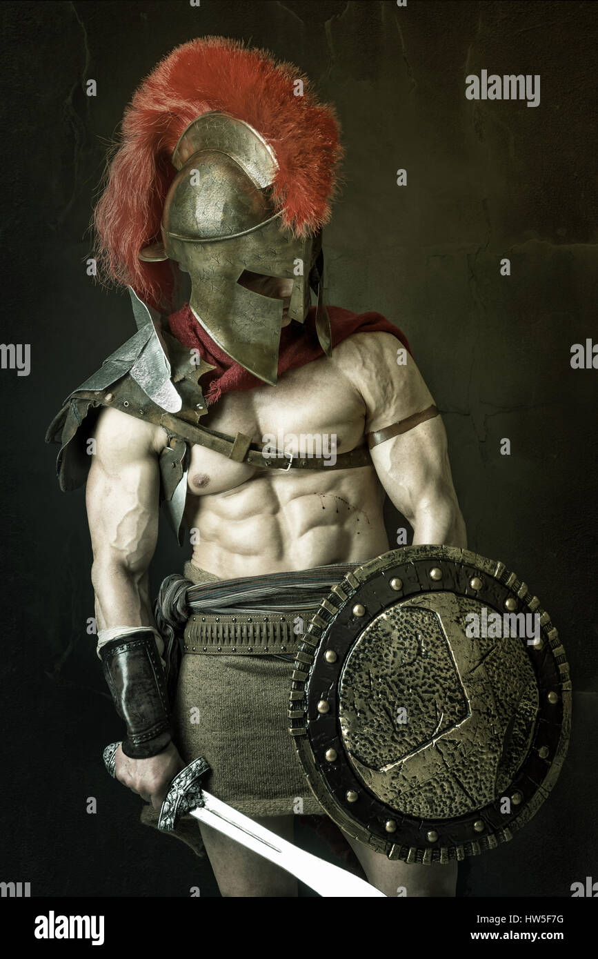 Ancient warrior or Gladiator posing over a dark background Stock Photo ...