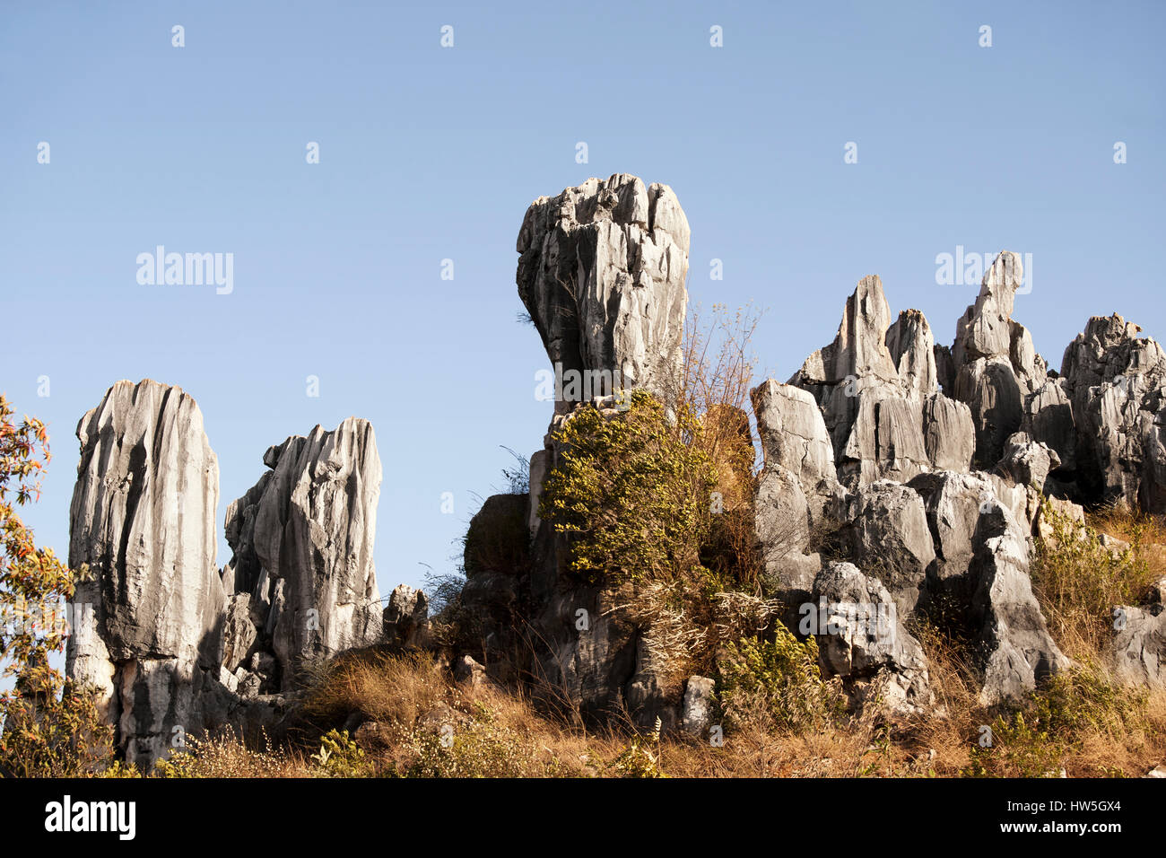 White grey colored tall standing rocks on a hill, China Stock Photo - Alamy