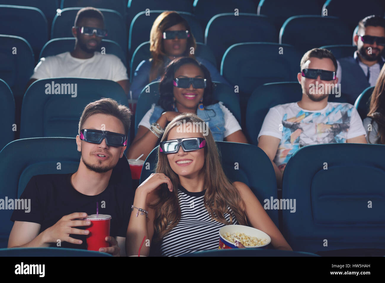 Couple talking in cinema and watching film Stock Photo - Alamy