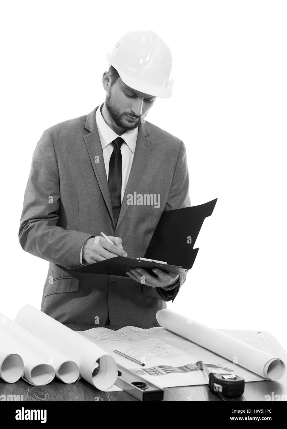 Professional male constructionist writing on his clipboard Stock Photo ...