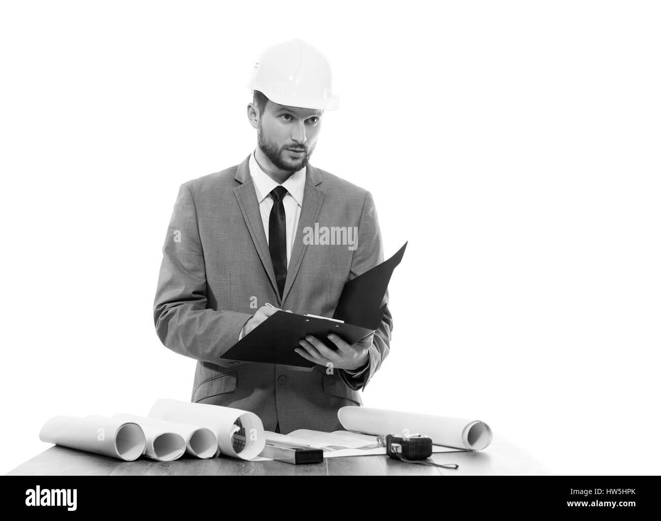 Professional male constructionist writing on his clipboard Stock Photo - Alamy