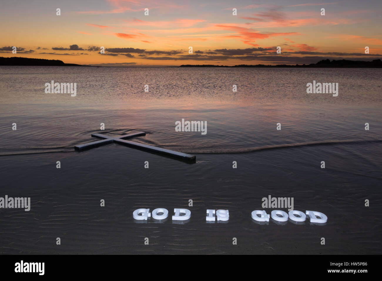 One floating cross with the words God is Good blow it, at sunset Stock ...