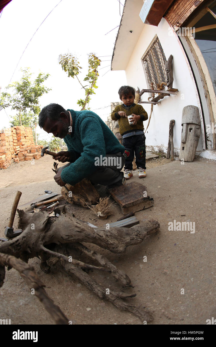 wood craven working on a root wood. Khajuraho, India Stock Photo - Alamy