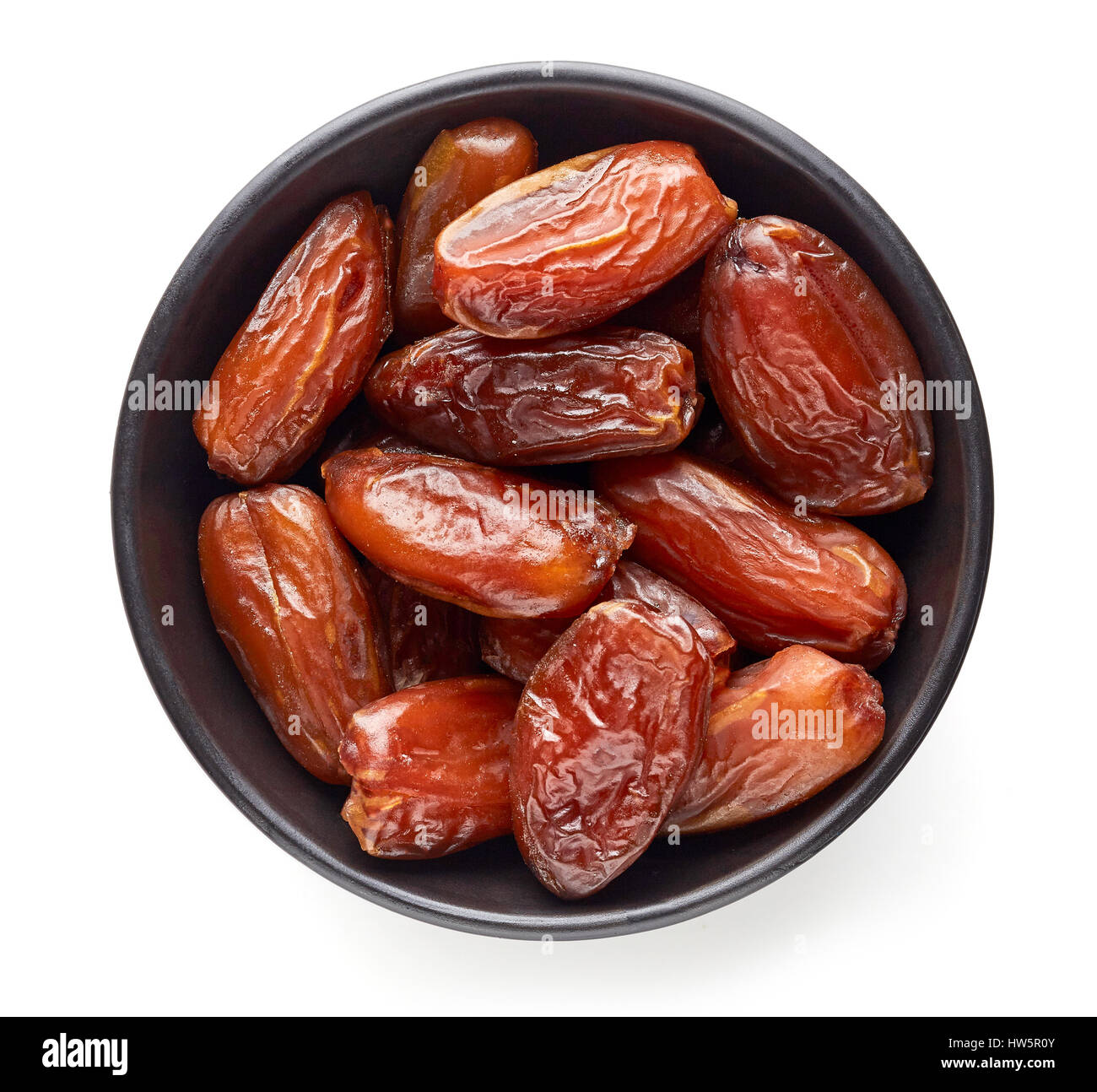 Bowl of pitted dates isolated on white background, top view Stock Photo ...