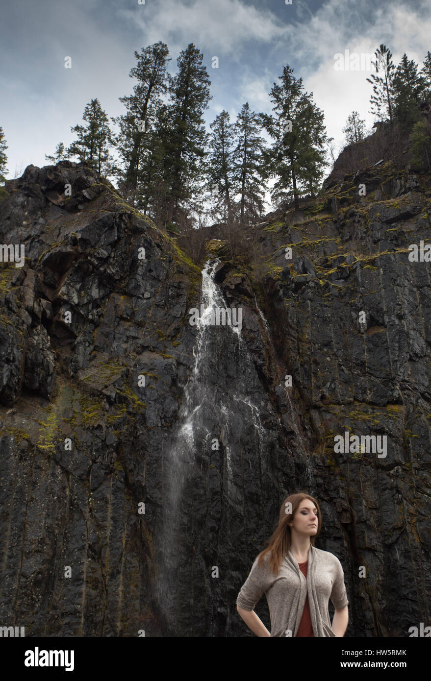 A woman stand beneath a waterfall in Montana Stock Photo - Alamy