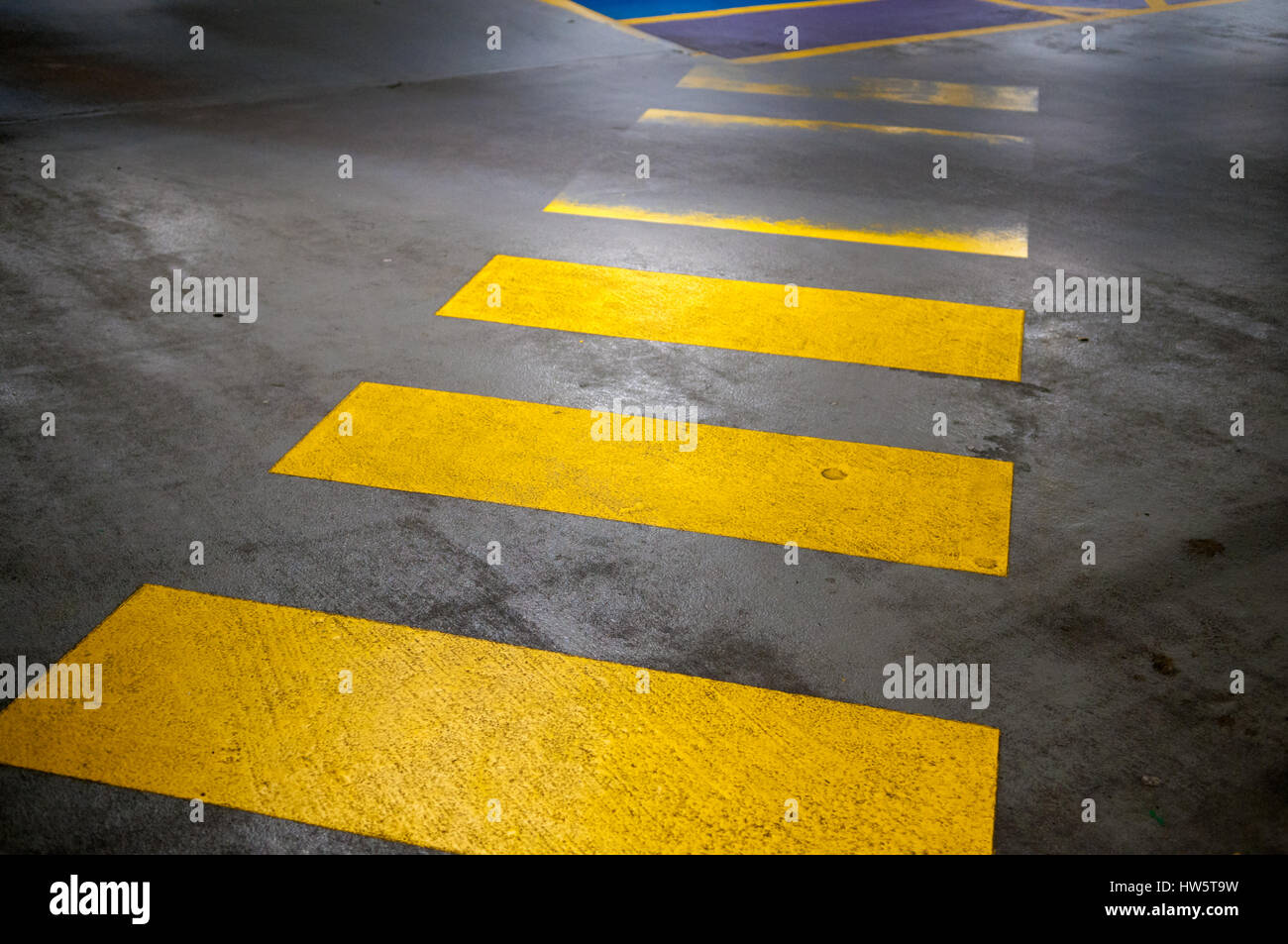 Worn out zebra crossing in yellow road markings Stock Photo - Alamy