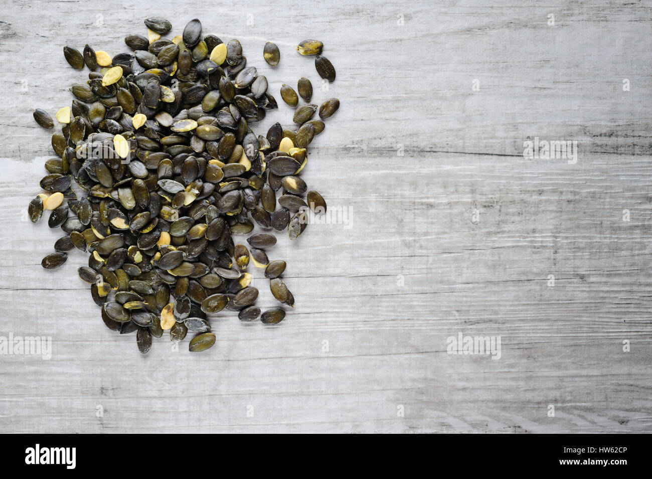 pumpkeen seeds scattered over white stone board Stock Photo - Alamy