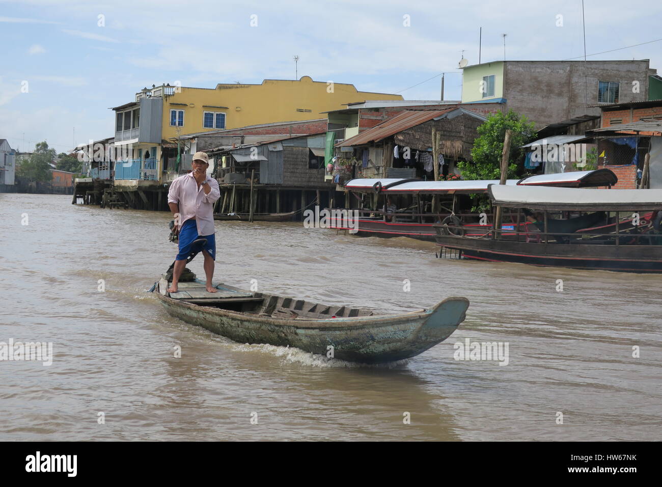 A shanty town at riverside of dirty river Mekong in Vietnam. Wooden ...