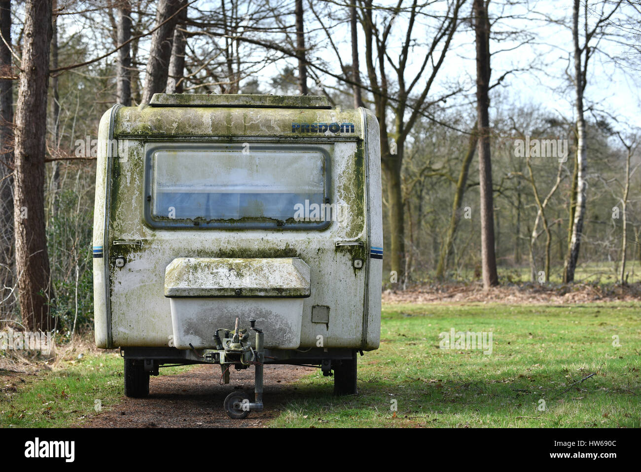 Front of a dirty vintage Polish-made PREDOM caravan of polyester on a ...