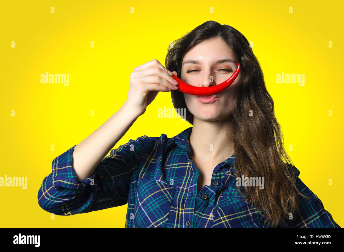 Girl and red chili pepper as mustache on yellow background Stock Photo ...