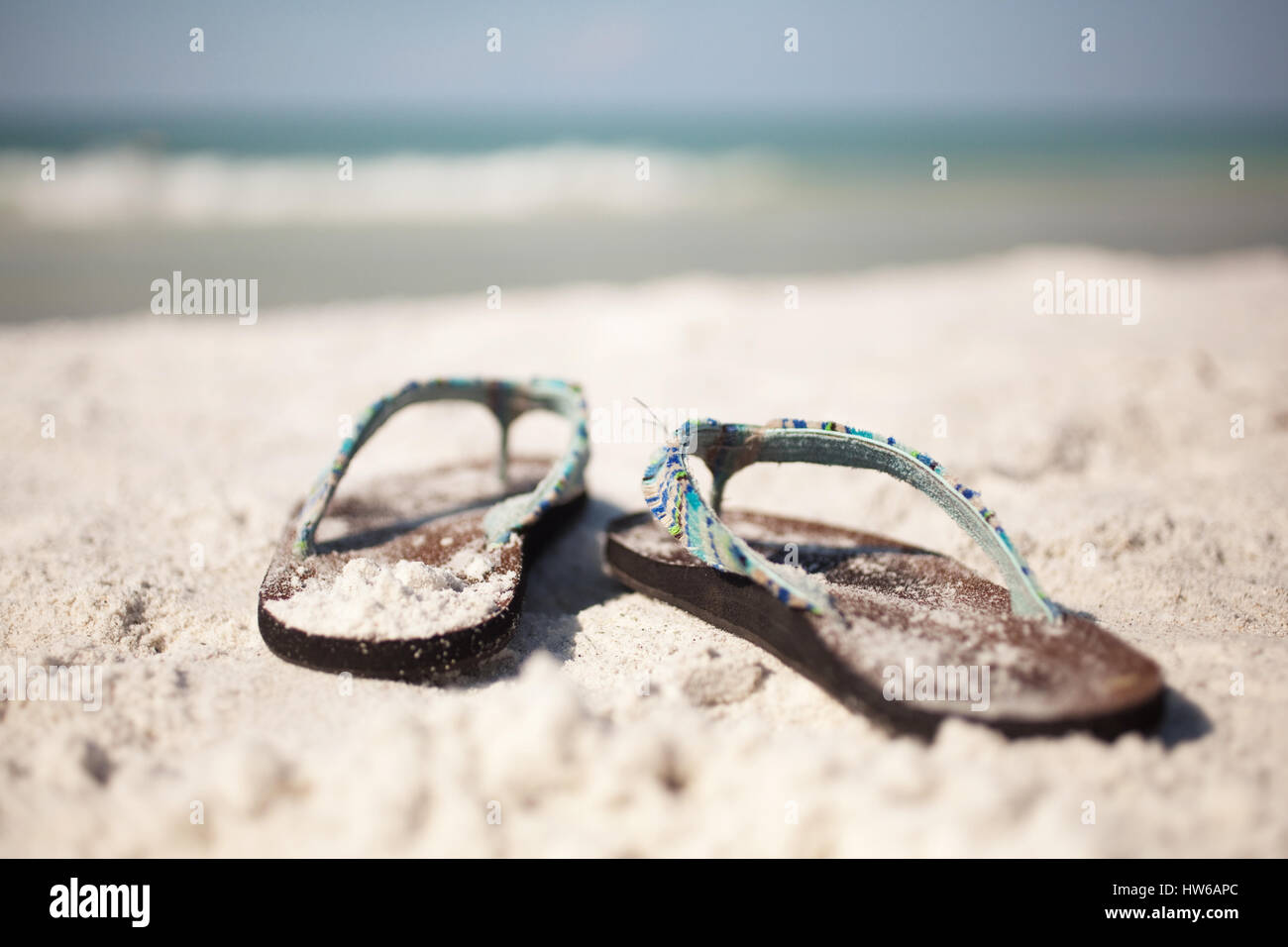 Sandals on the beach Stock Photo - Alamy
