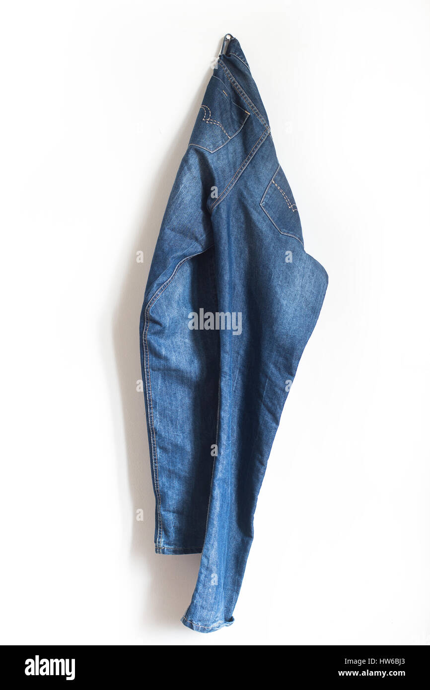 vertical front view of a pair of blue jeans male pants hanging on a ...