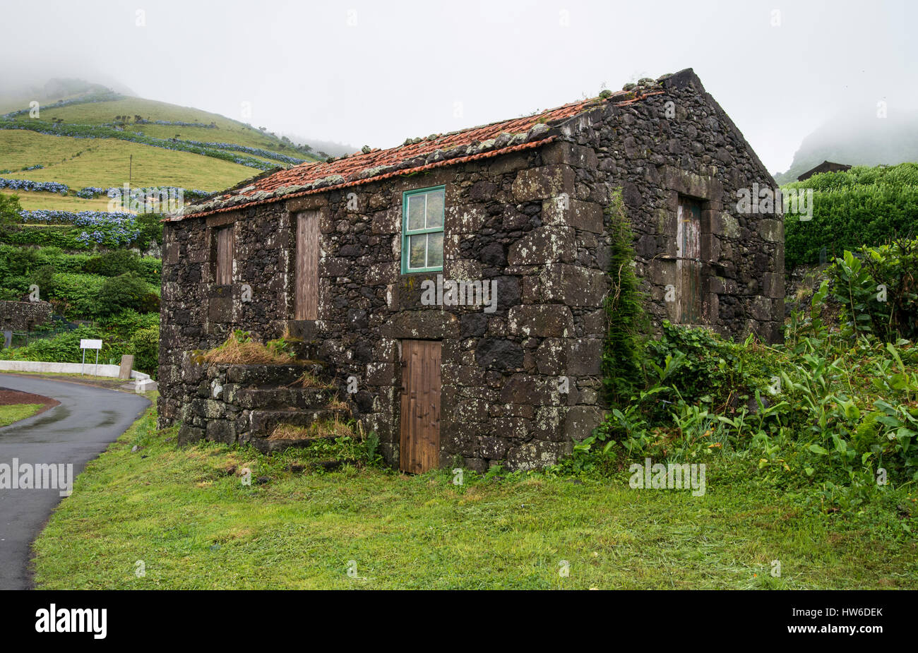 Traditional stone house in green landscape of Azores island Stock Photo ...