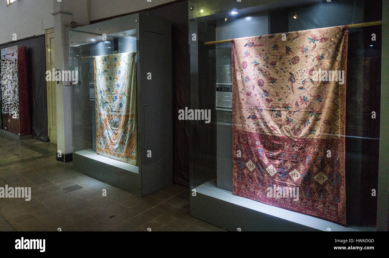 Batik fabric collection displayed in glass cabinet with lighting photo ...