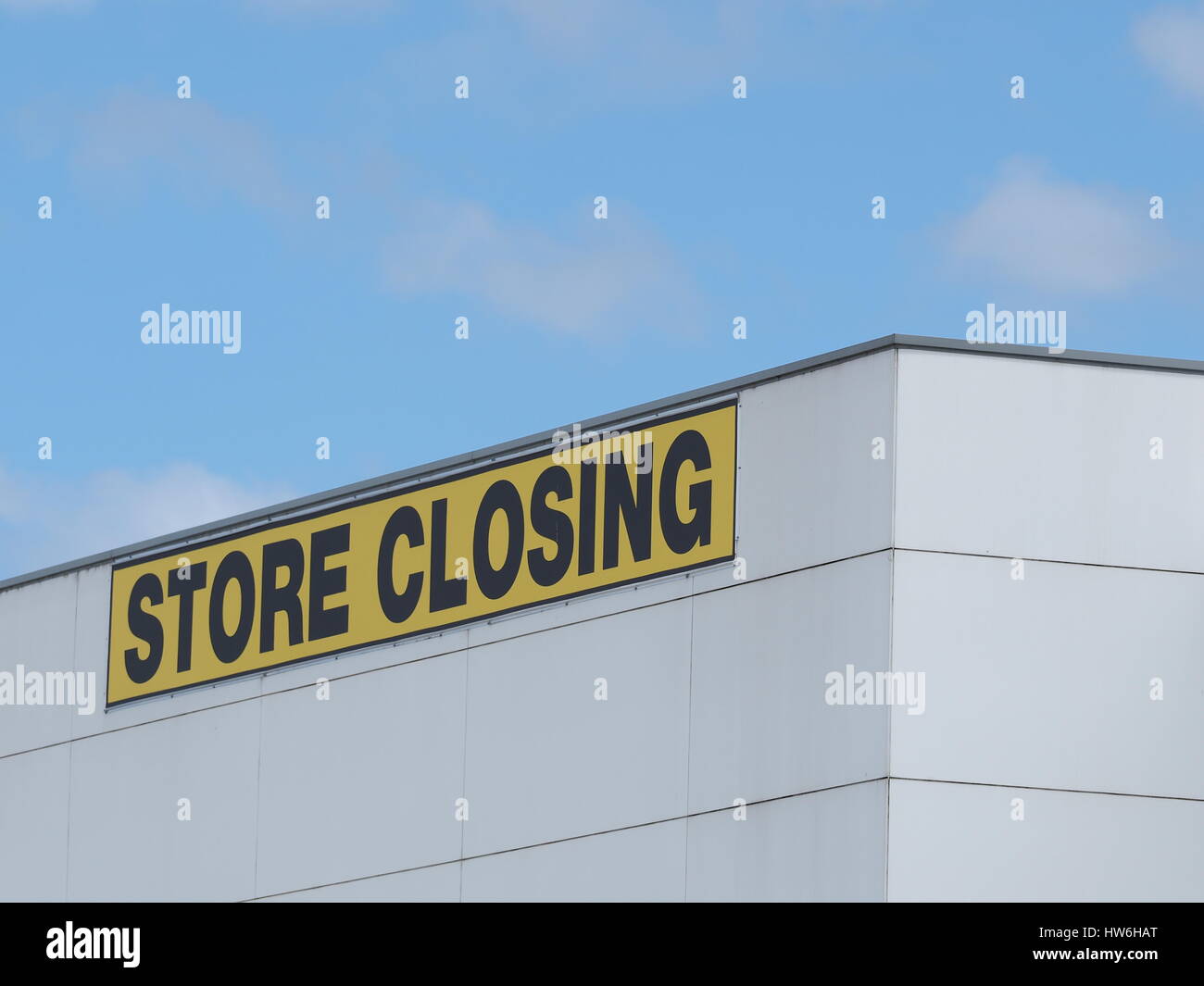 Store Closing black on yellow letters on a white cladded industrial ...