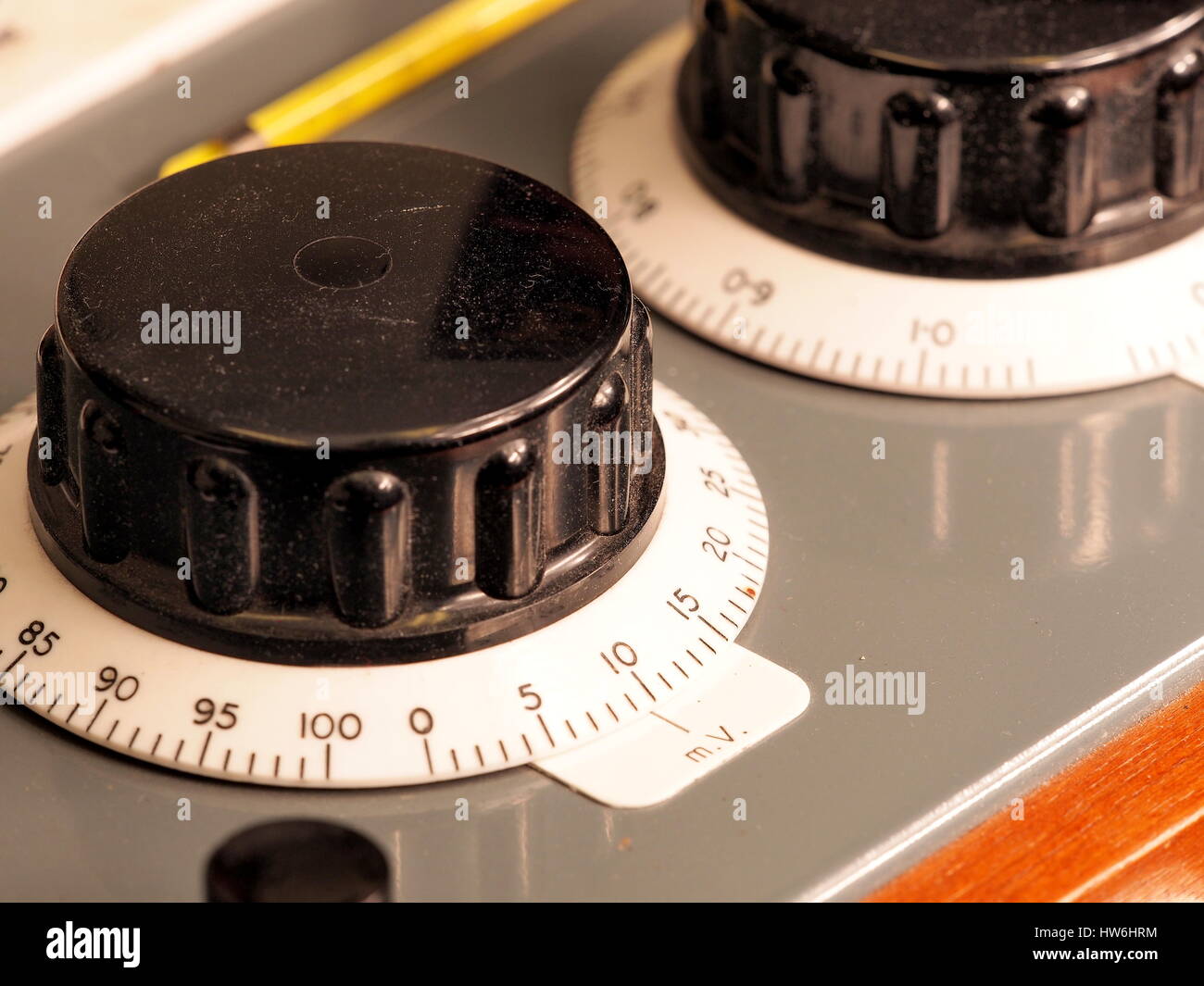 Big black hand knobs with rotating scale on an old test apparatus ...