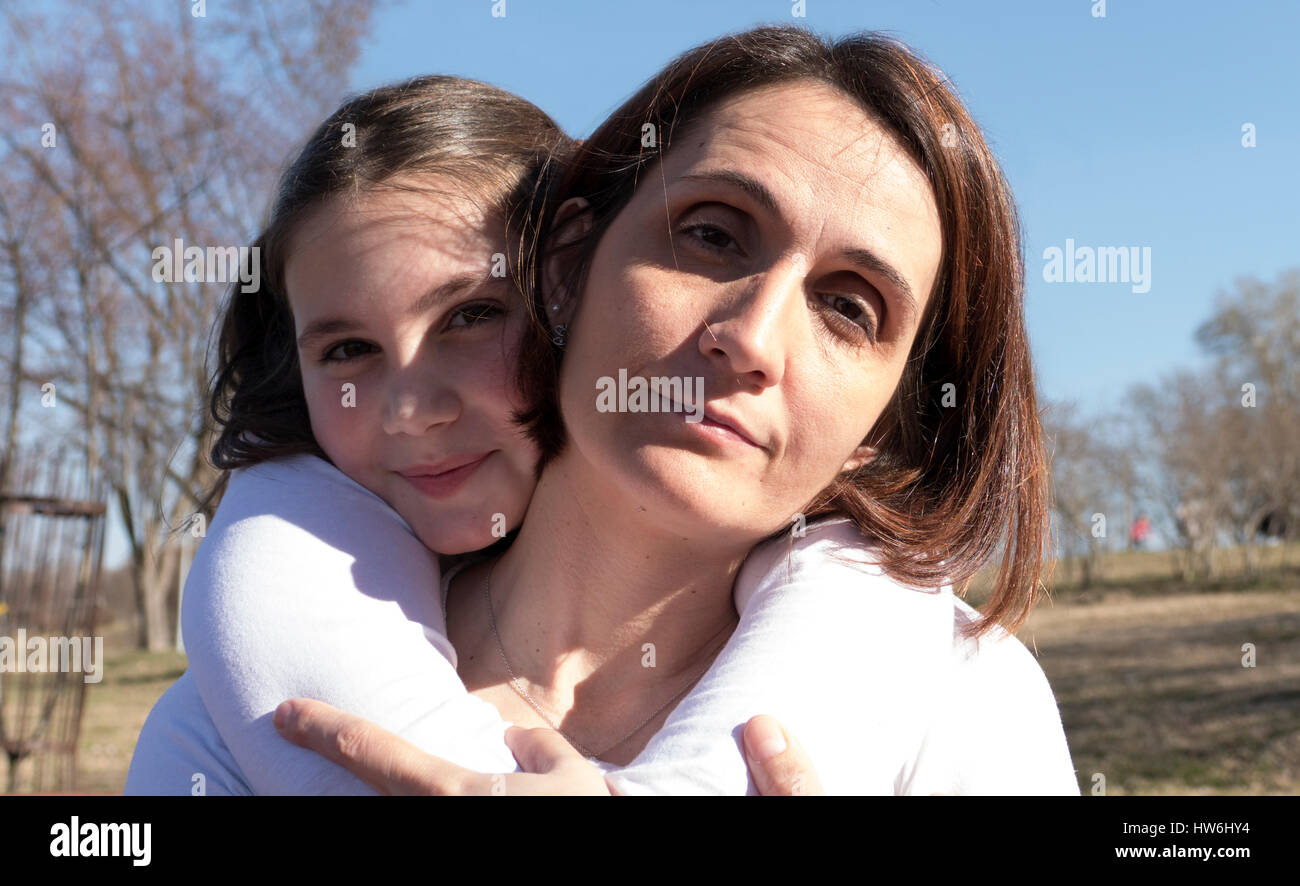 Mother and Daughter hugging in park during the sunny spring day Stock Photo - Alamy