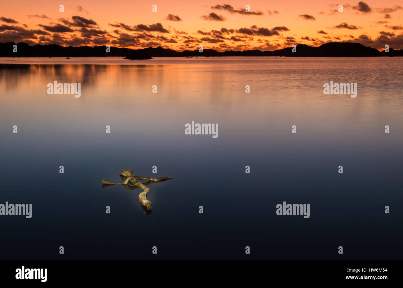 Drift wood cross on flat still waters of a lake Stock Photo - Alamy