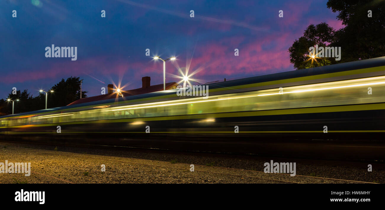 High speed express train zooming past a railway station Stock Photo - Alamy
