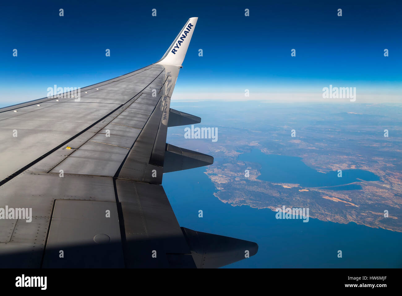View of airplane wing through window Stock Photo - Alamy