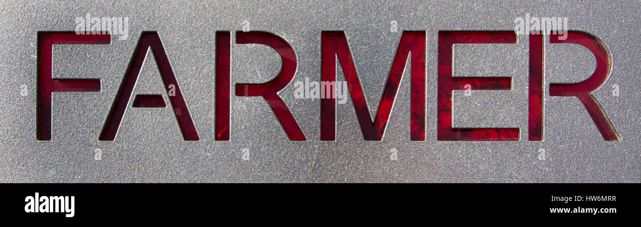 Nice red lettering into a sandy metal surface, spelling Farmer Stock ...