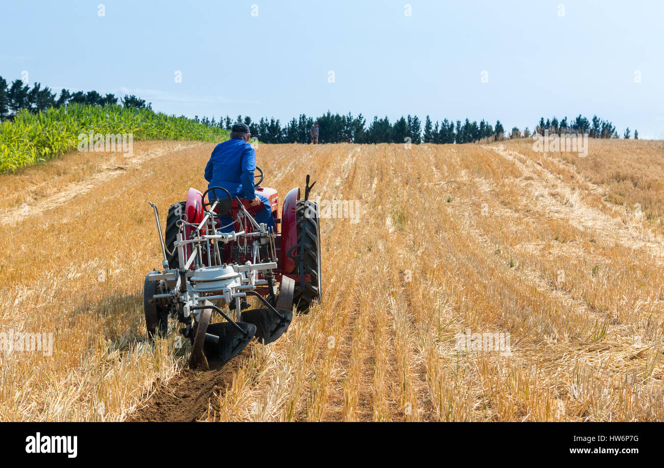 Farmer making the first plough cut straight up a hill Stock Photo - Alamy