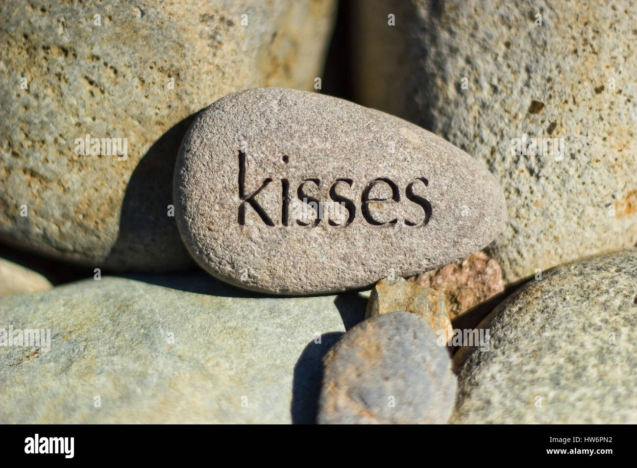 A carved rock in the middle of a pile of stone rocks with the message ...