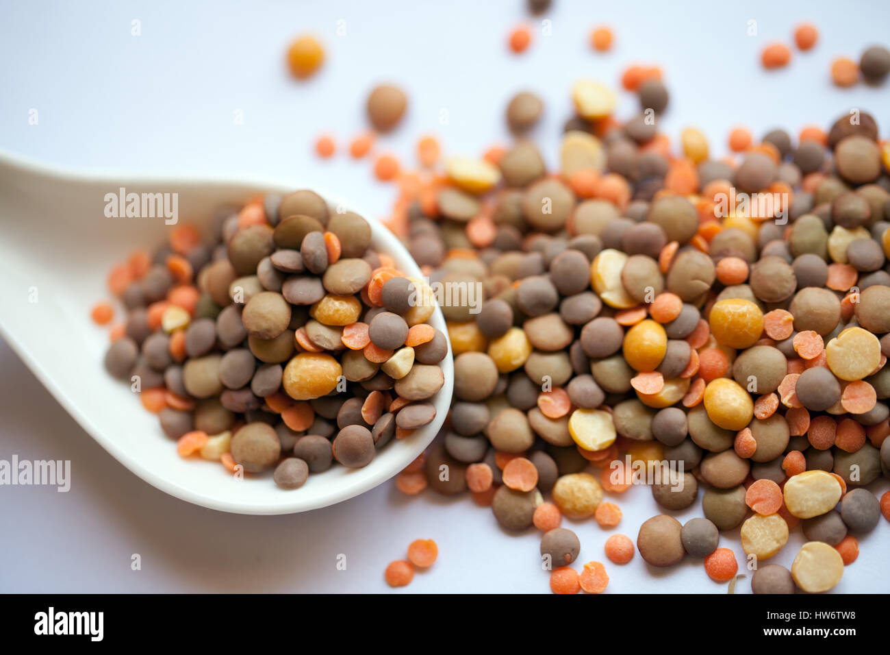 Mixed dried lentils in a white ceramic spoon Stock Photo - Alamy