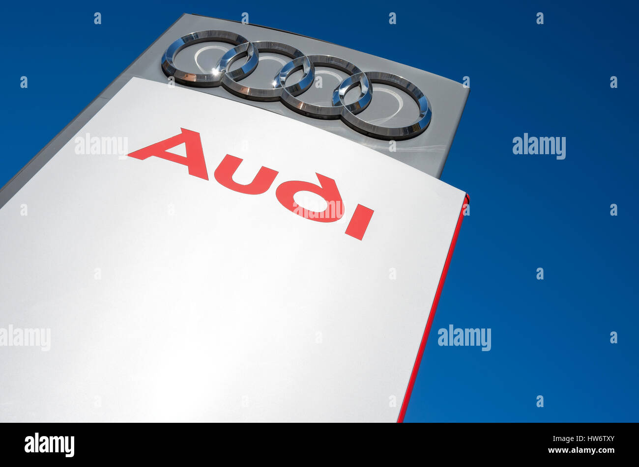 Audi dealership sign against blue sky Stock Photo - Alamy