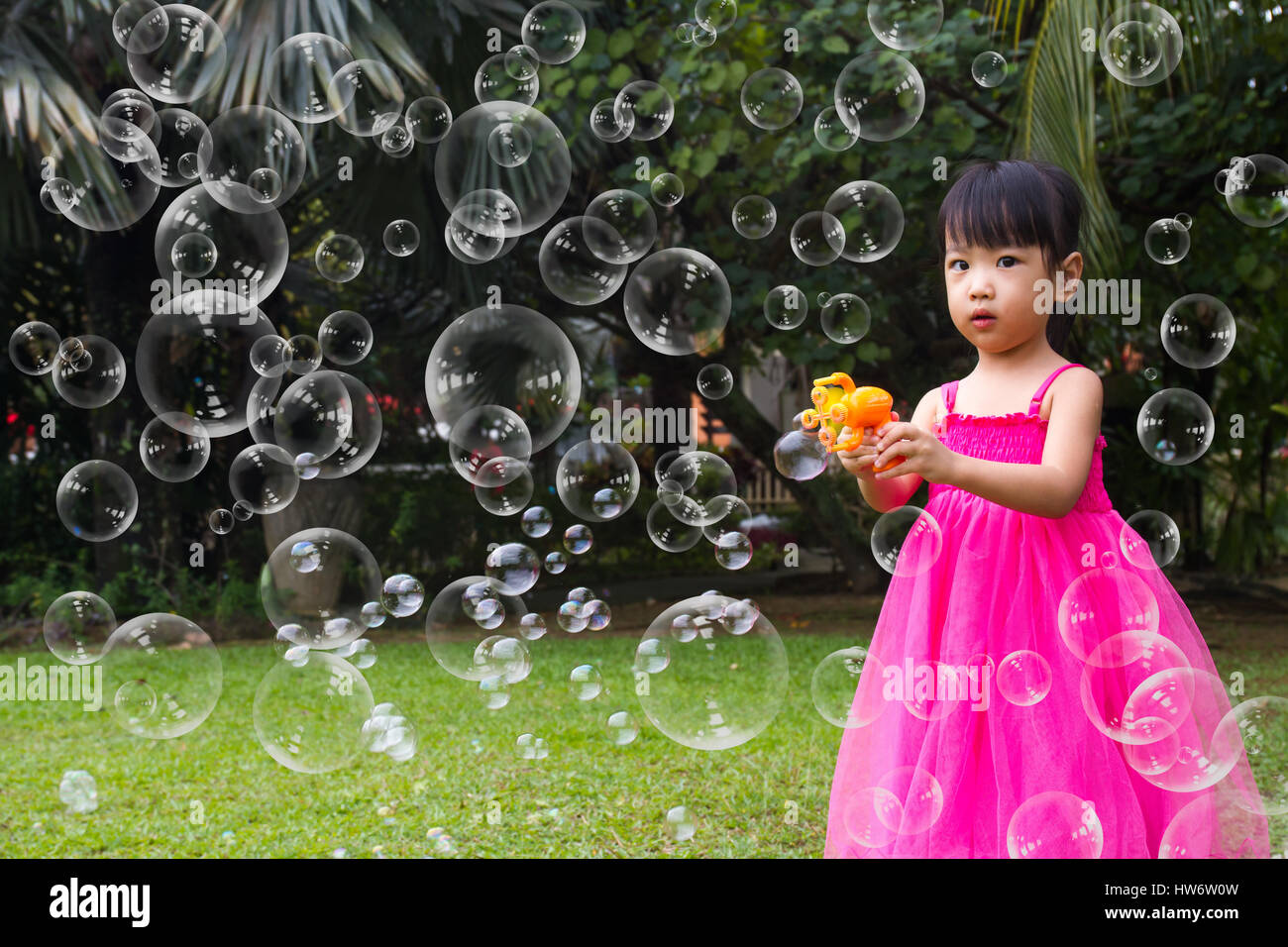 Asian Little Chinese Girls Shooting Bubbles from Bubble Blower in the ...