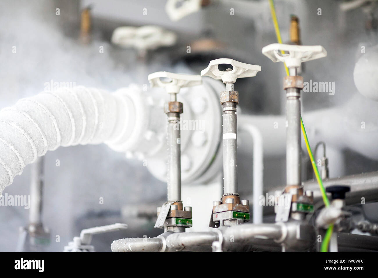 Industrial zone, pipes valve connection Stock Photo - Alamy