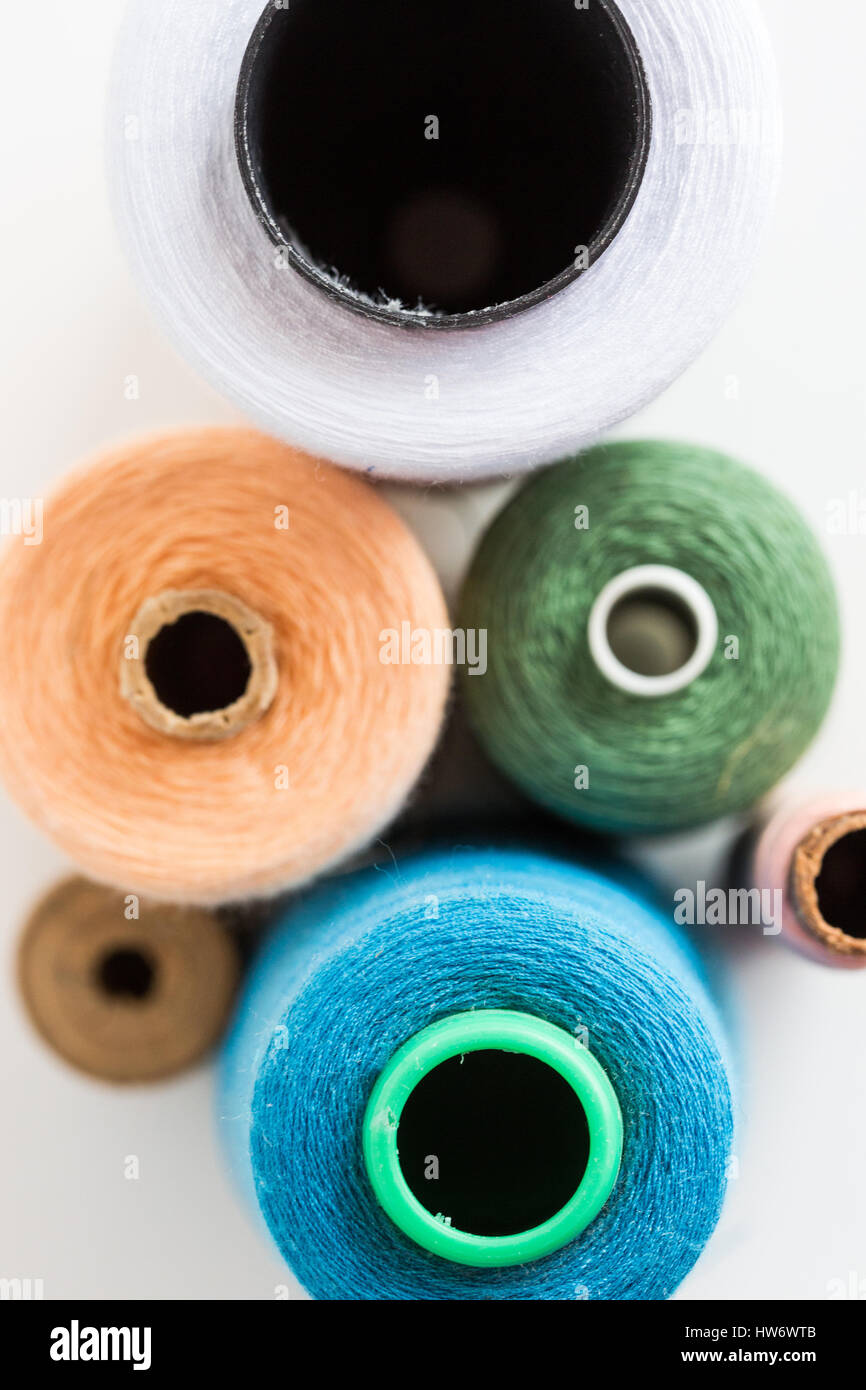 Concept of blurred colored threads for sewing. different sizes of the ...