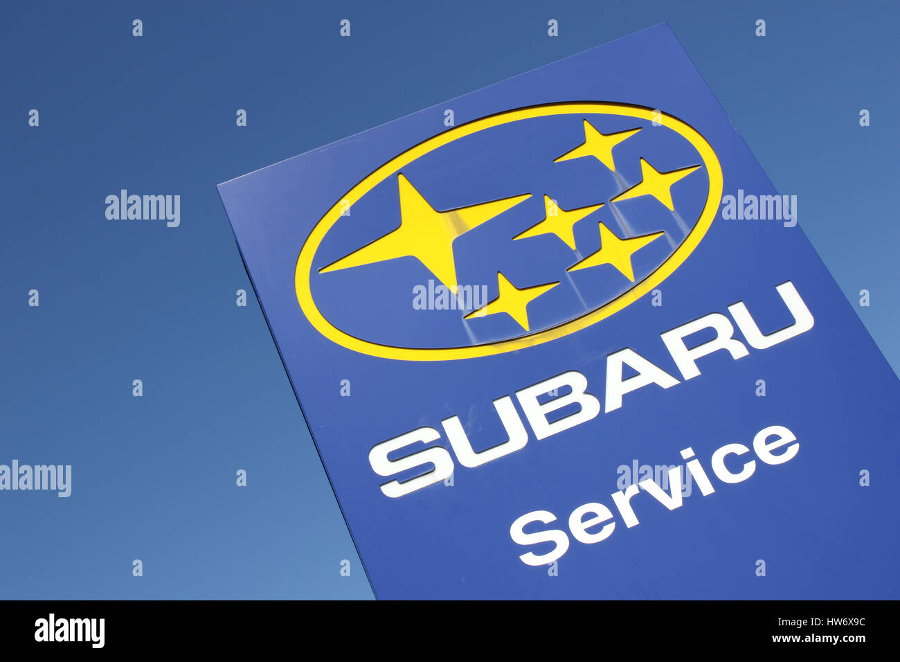 Subaru dealership sign against blue sky Stock Photo - Alamy