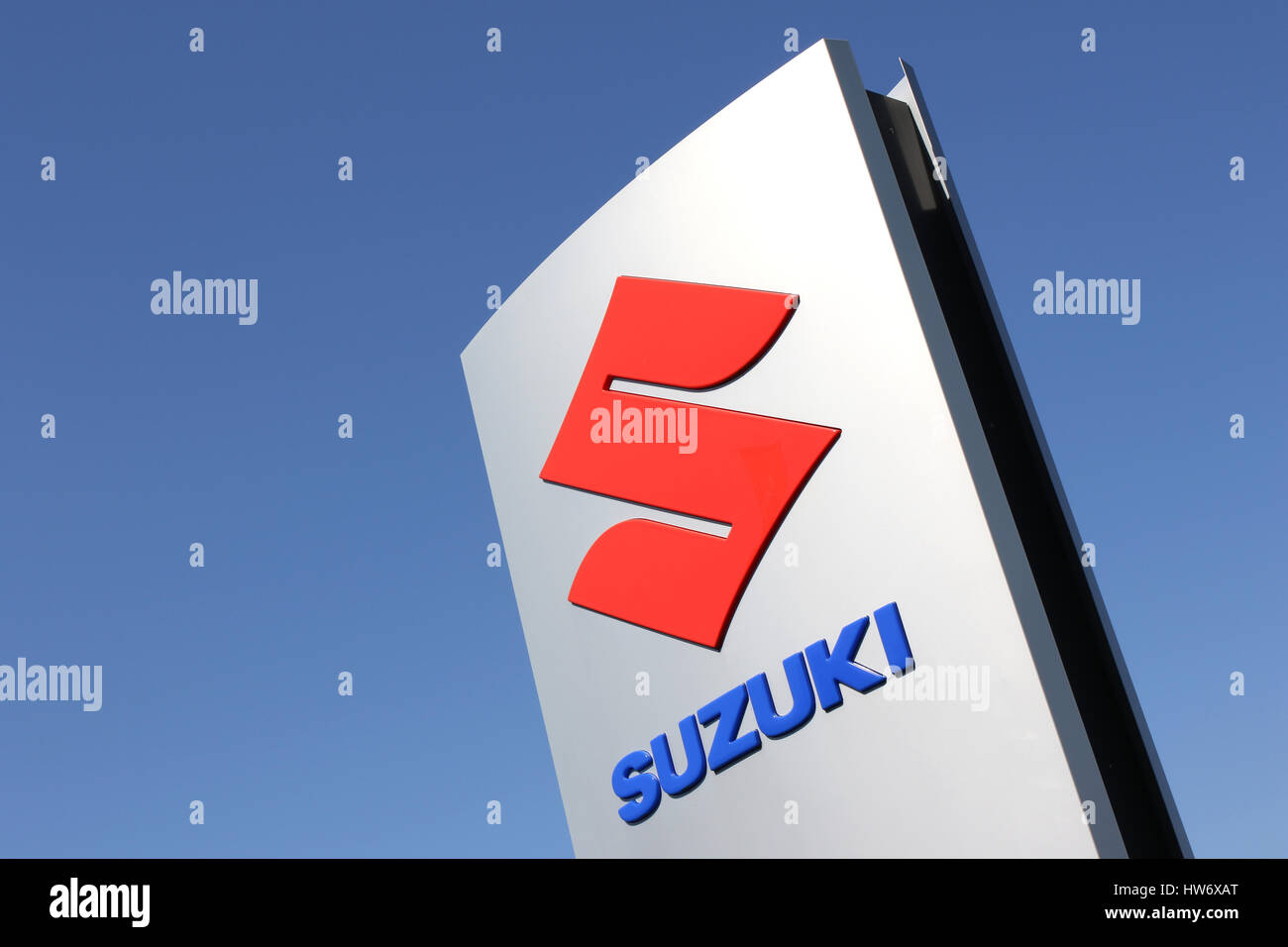 Suzuki dealership sign against blue sky Stock Photo - Alamy