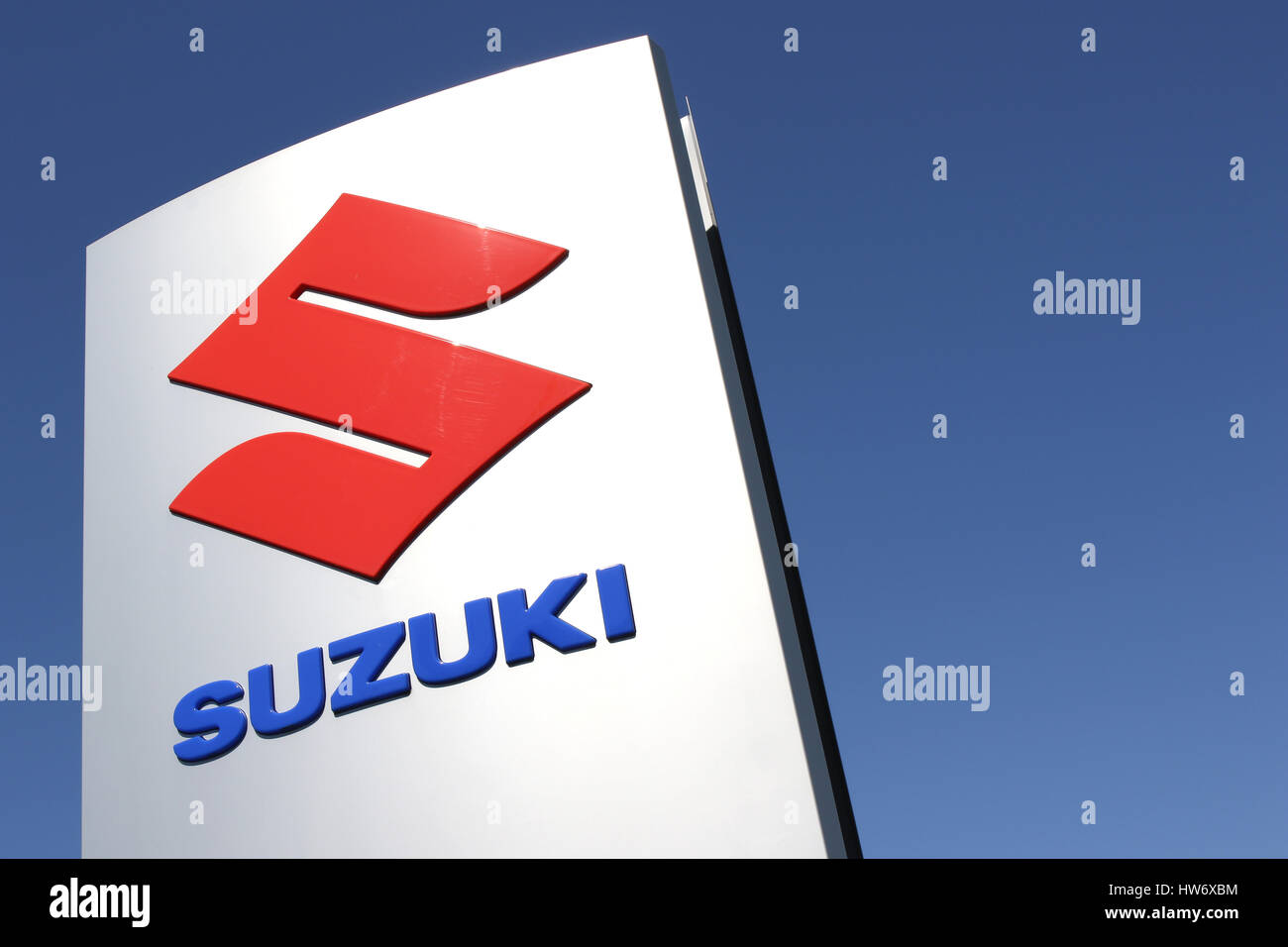 Suzuki dealership sign against blue sky Stock Photo - Alamy