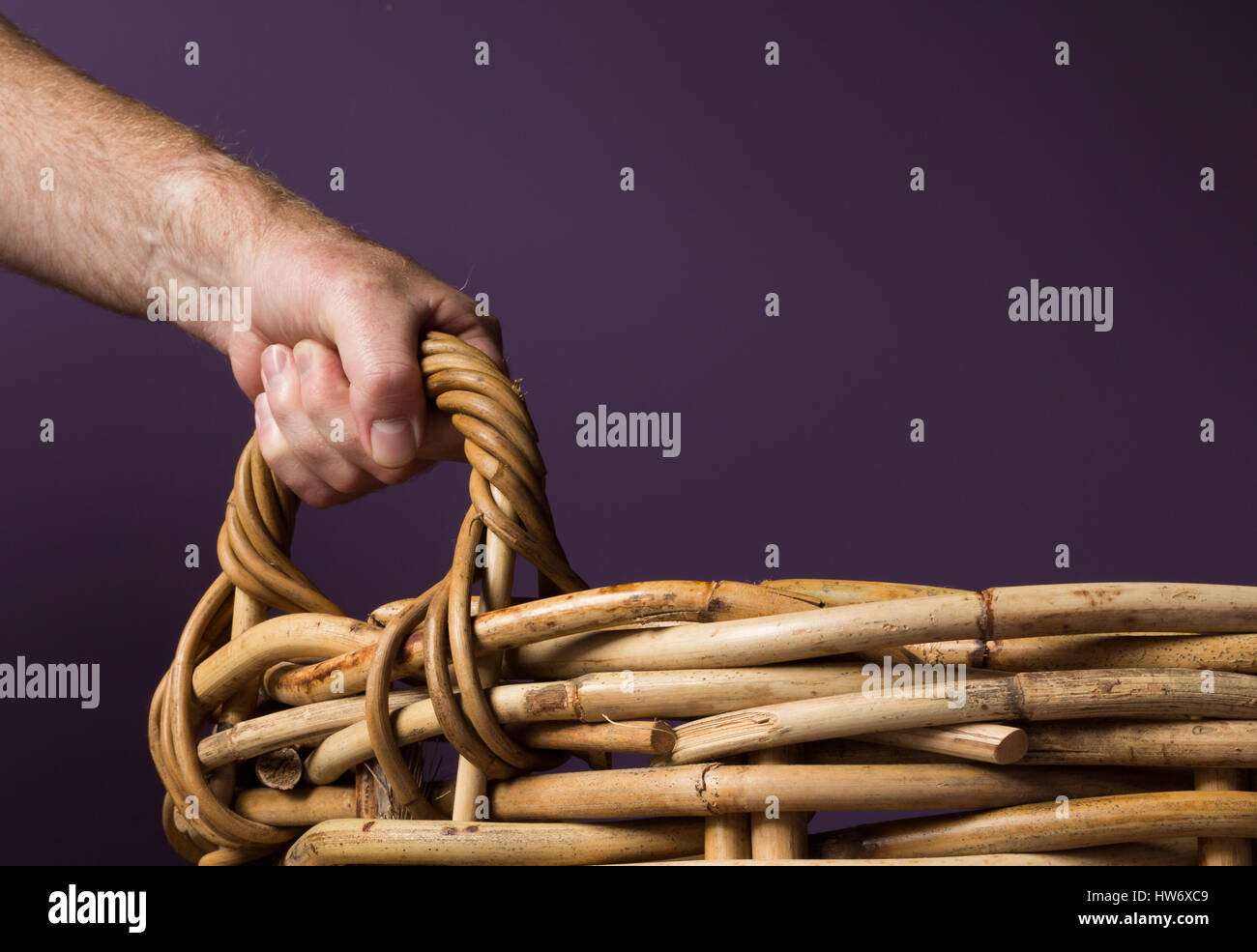 Hand gripping a large cane basket handle Stock Photo - Alamy