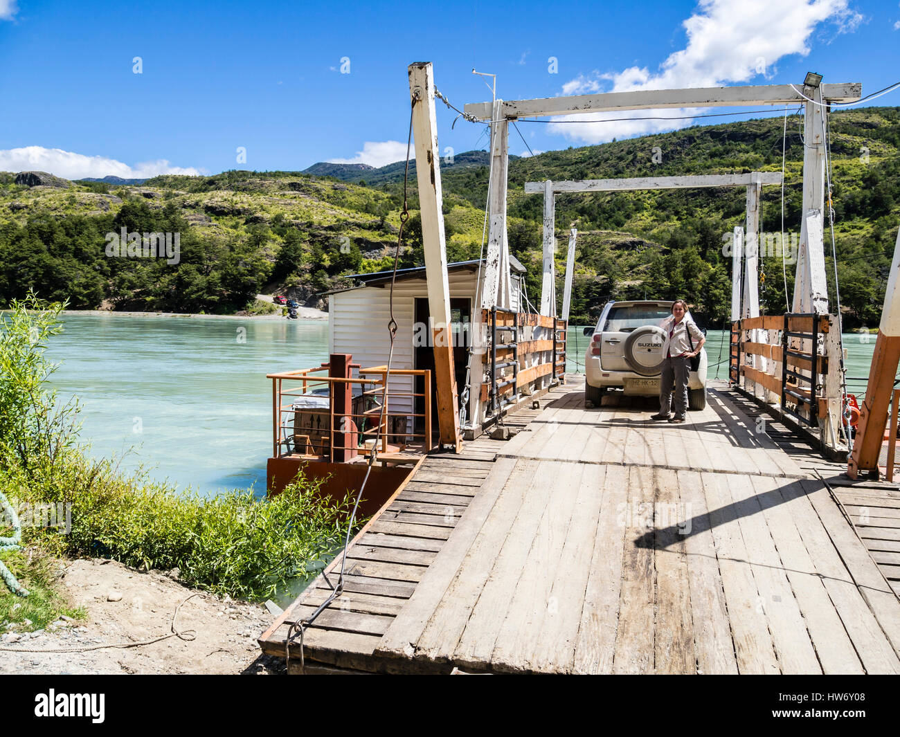 Ferry crossing the river Rio Baker, driven by the stream of the river ...