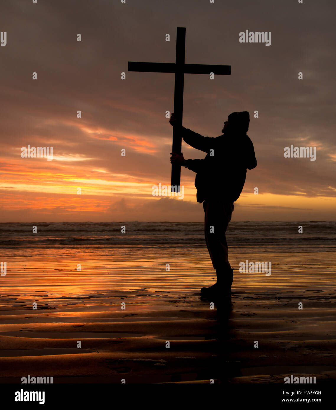 Christian man holding cross easter hi-res stock photography and images ...